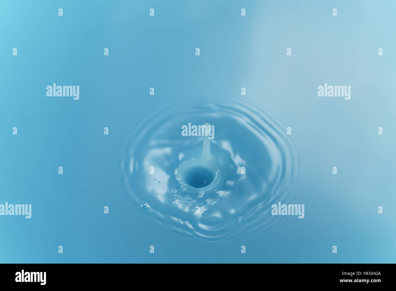 splash on light blue water surface from above Stock Photo - Alamy