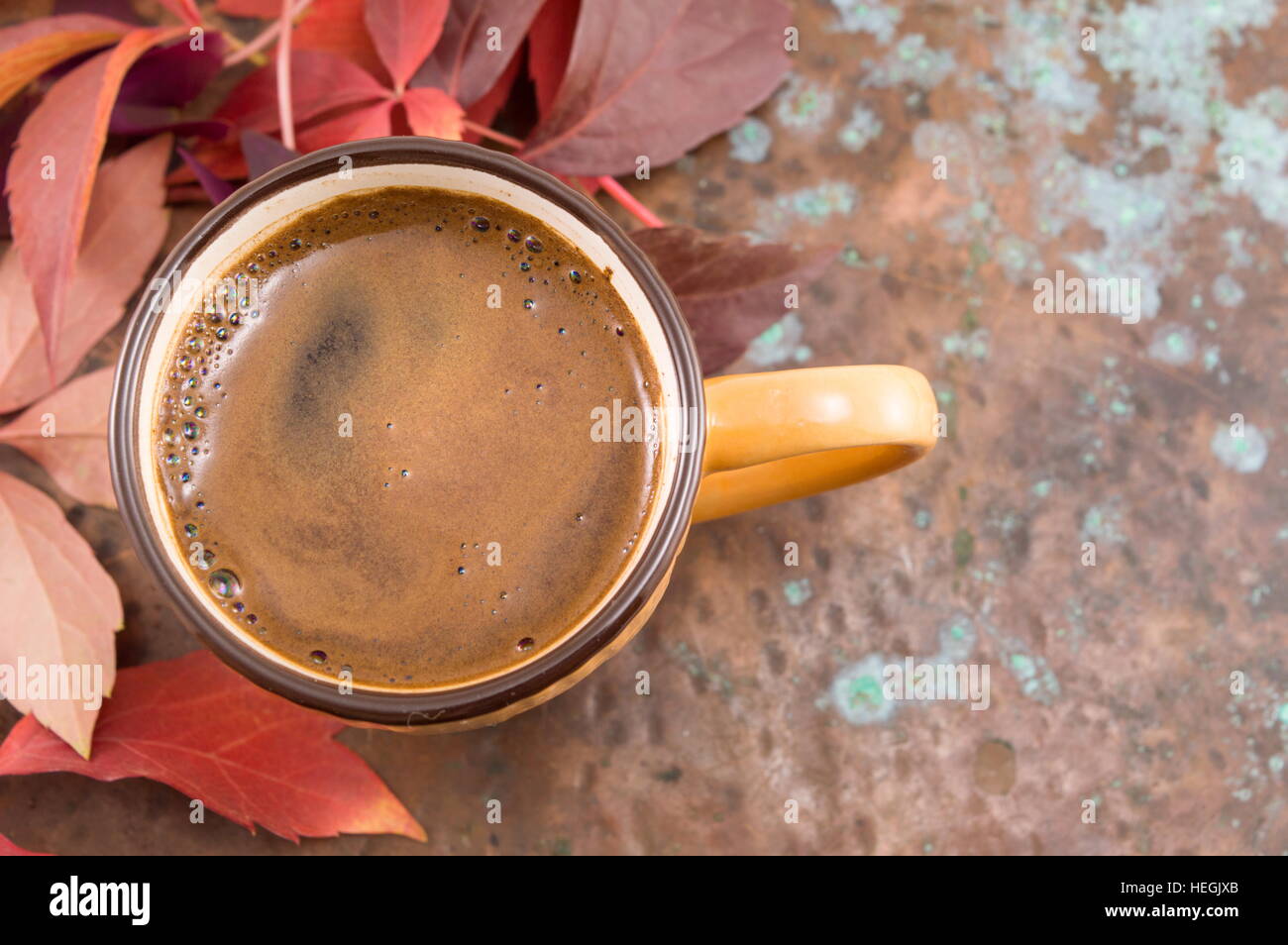 Cup of coffee in and fallen red autumn leaves Stock Photo - Alamy
