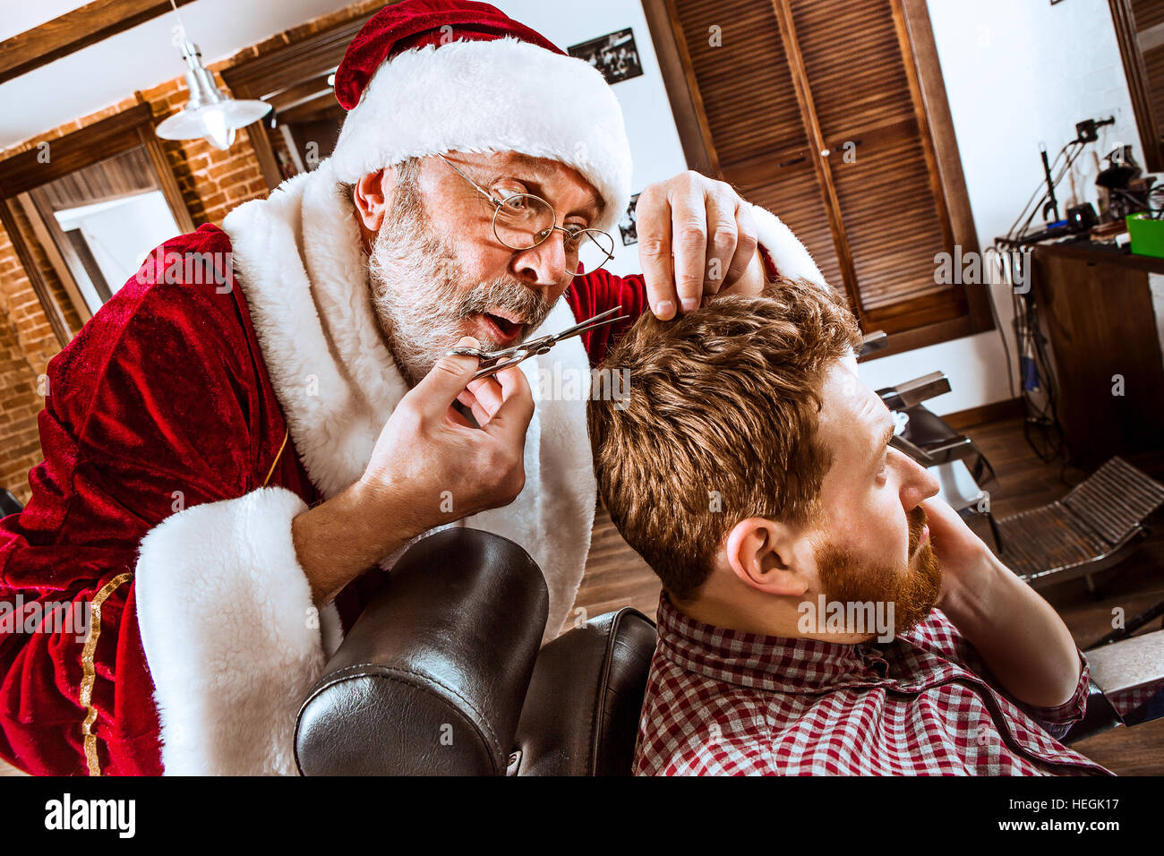 Santa claus as master at barber shop Stock Photo - Alamy