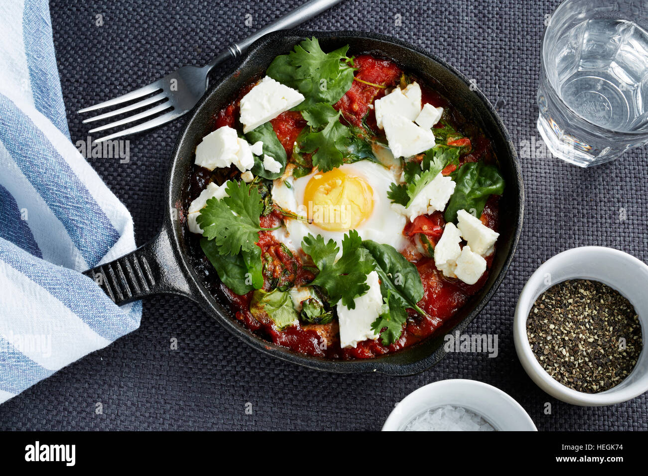 baked eggs feta skillet frying pan Stock Photo - Alamy
