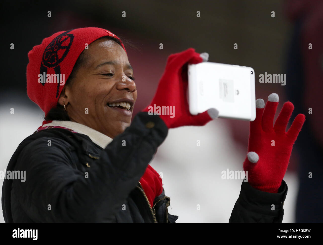 An Arsenal fan takes a photograph during the Premier League match at ...