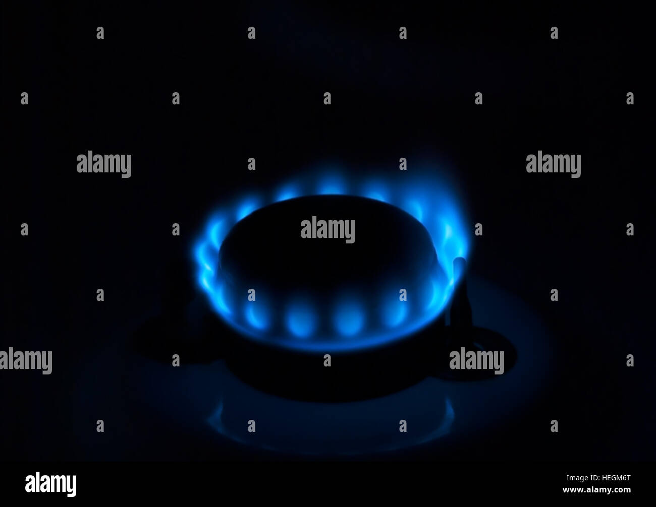 Natural gas burning a blue flames on black background Stock Photo - Alamy