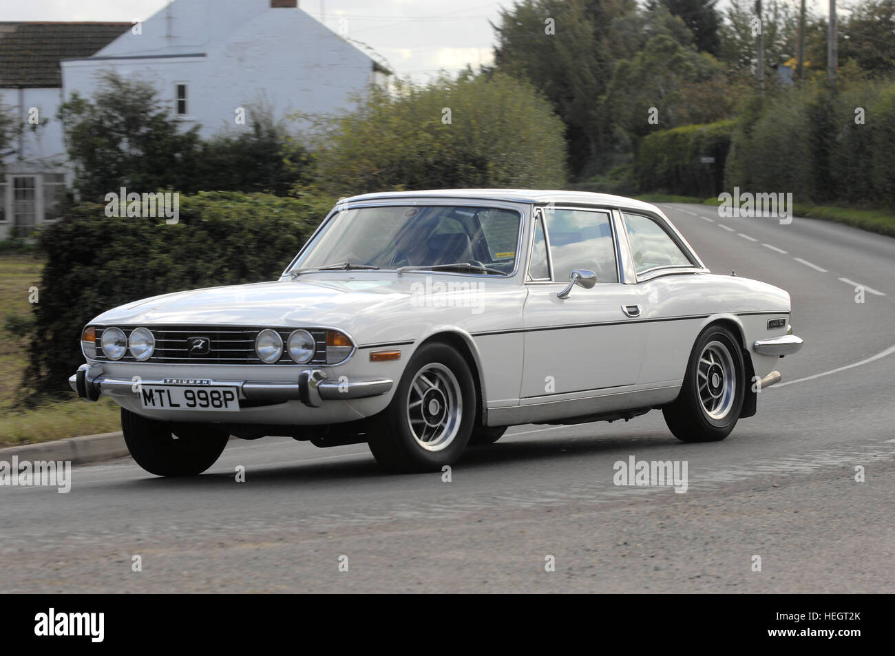 White Triumph Stag hardtop tracking action shot Stock Photo - Alamy