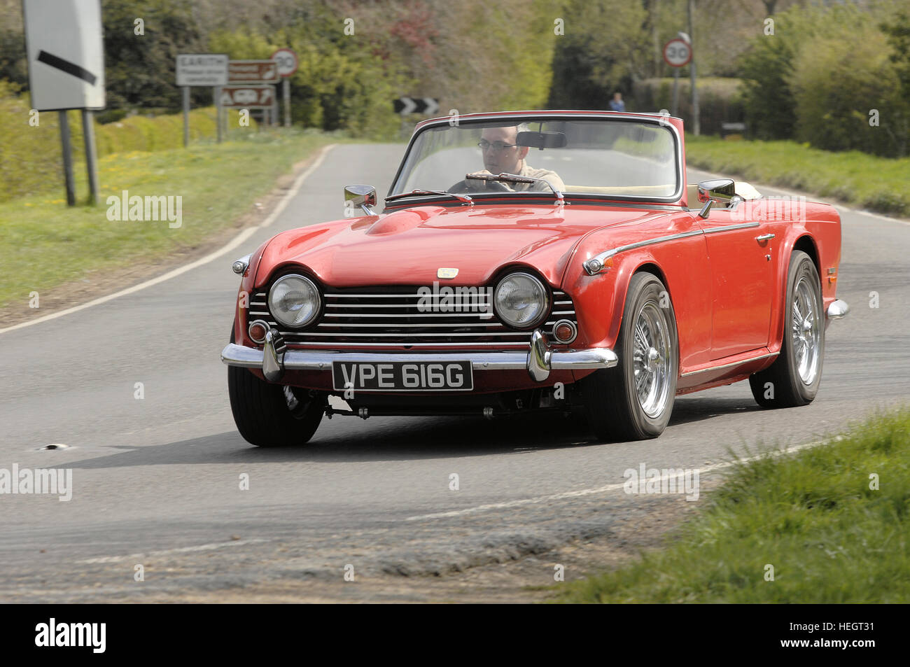 Convertible red Triumph TR5 in action with top down Stock Photo - Alamy