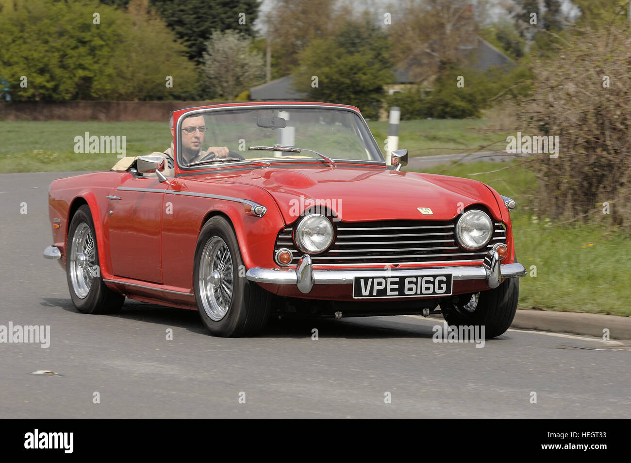 Convertible red Triumph TR5 in action with top down Stock Photo - Alamy