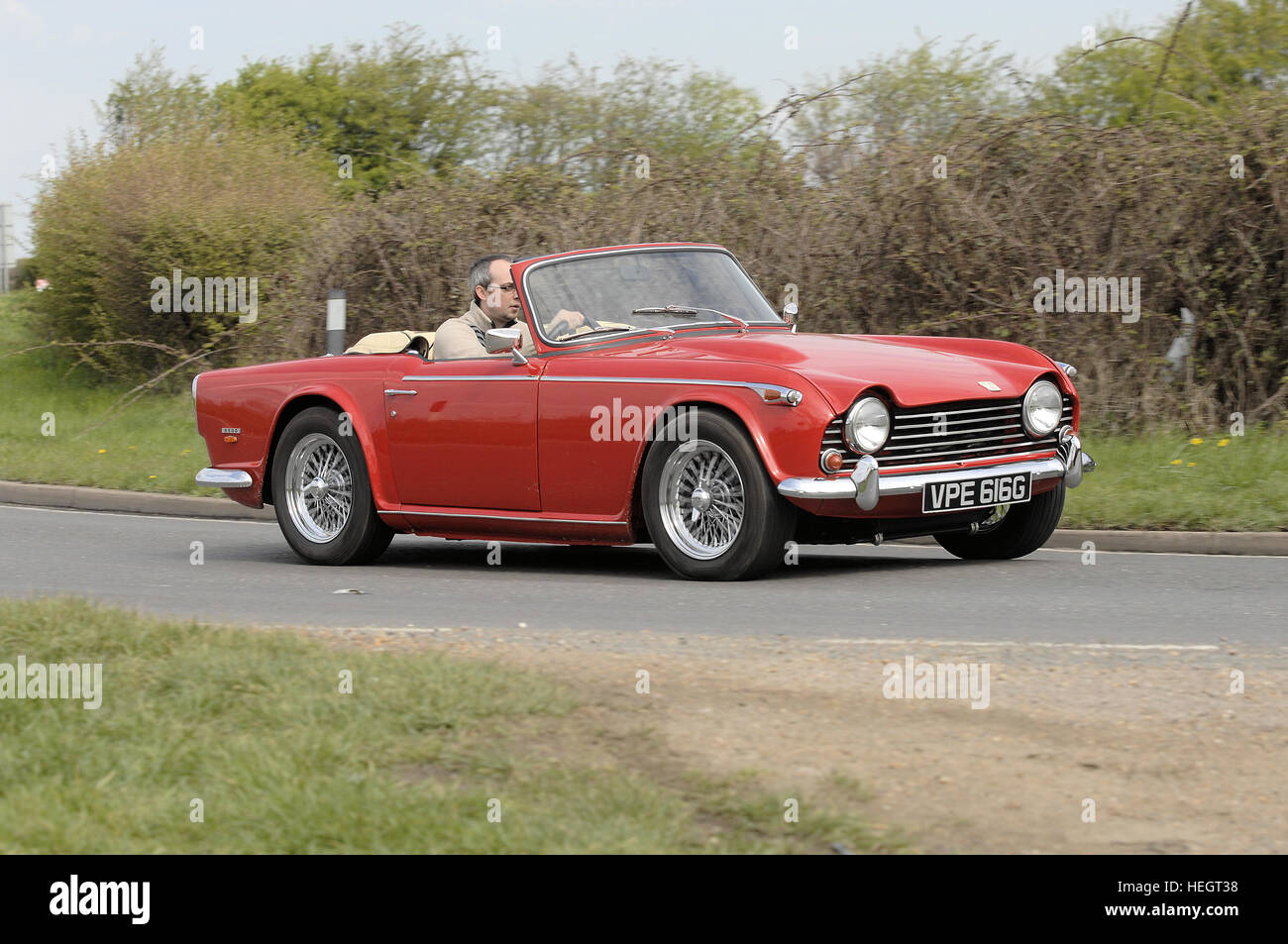 Convertible red Triumph TR5 in action with top down Stock Photo - Alamy