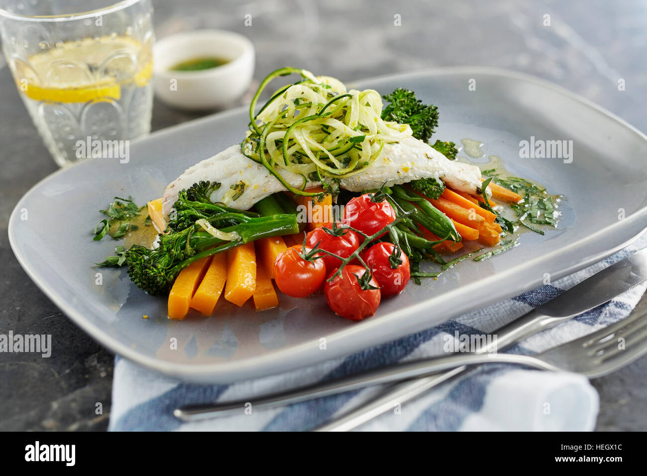 sea bass steamed butterd vegetables Stock Photo - Alamy