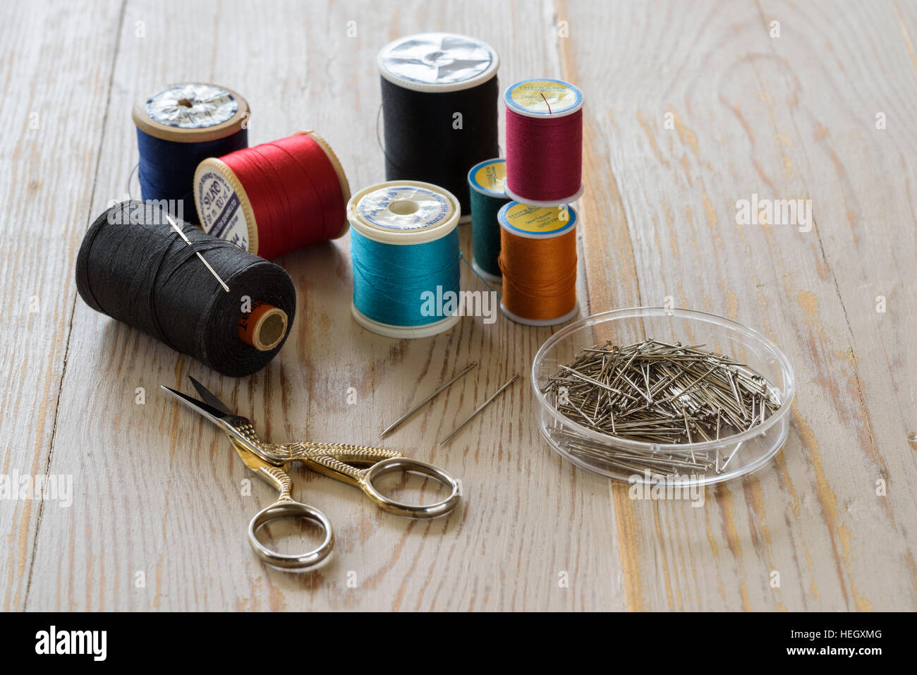 Group of cotton reels, with scissors and pins Stock Photo - Alamy