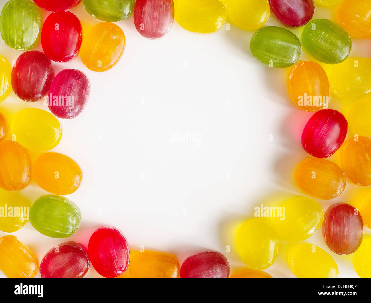 Round colored fruit candy frame on white Stock Photo - Alamy
