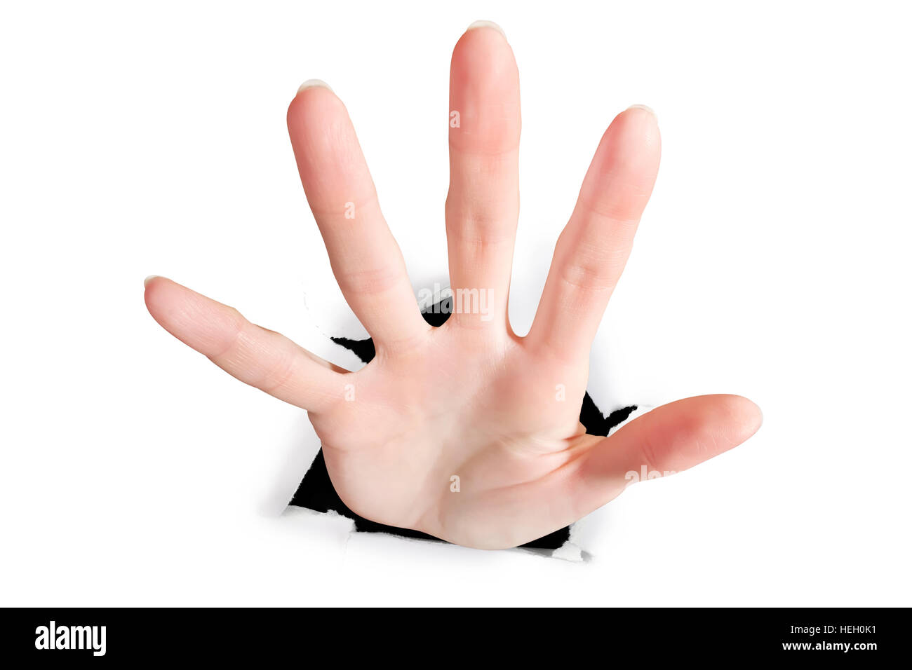 Female hand break through the paper. On white, wide angle view ...