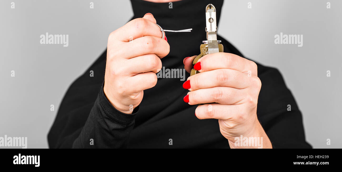 Hand grenade in a woman's hand with the pin pulled Stock Photo - Alamy