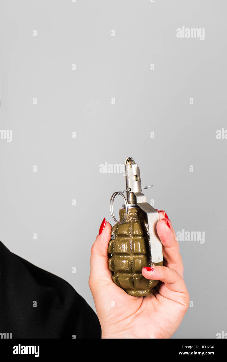 Hand grenade in a woman's hand Stock Photo - Alamy