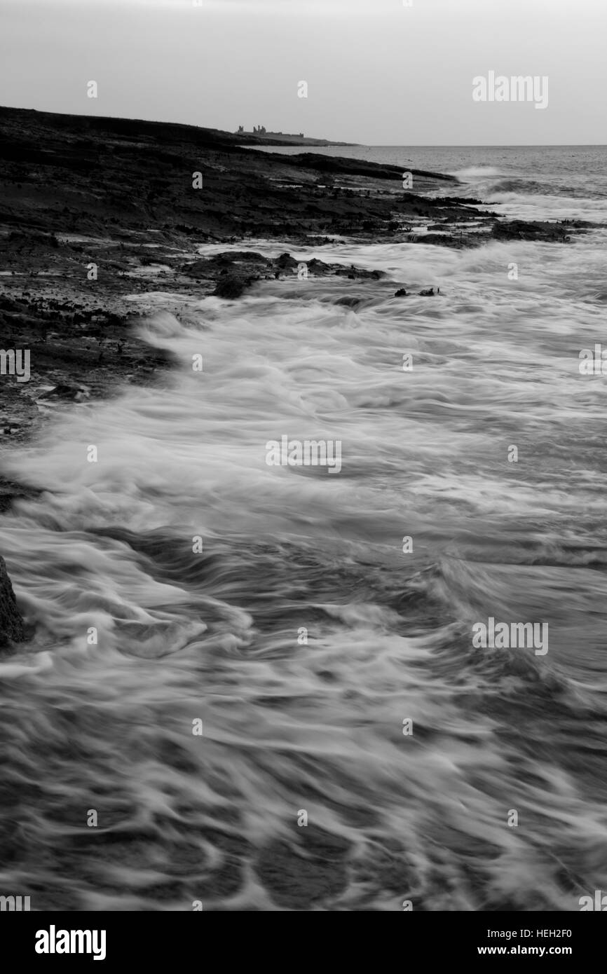 Distant view of Dunstanburgh Castle from Rumbling Kern, Northumberland ...