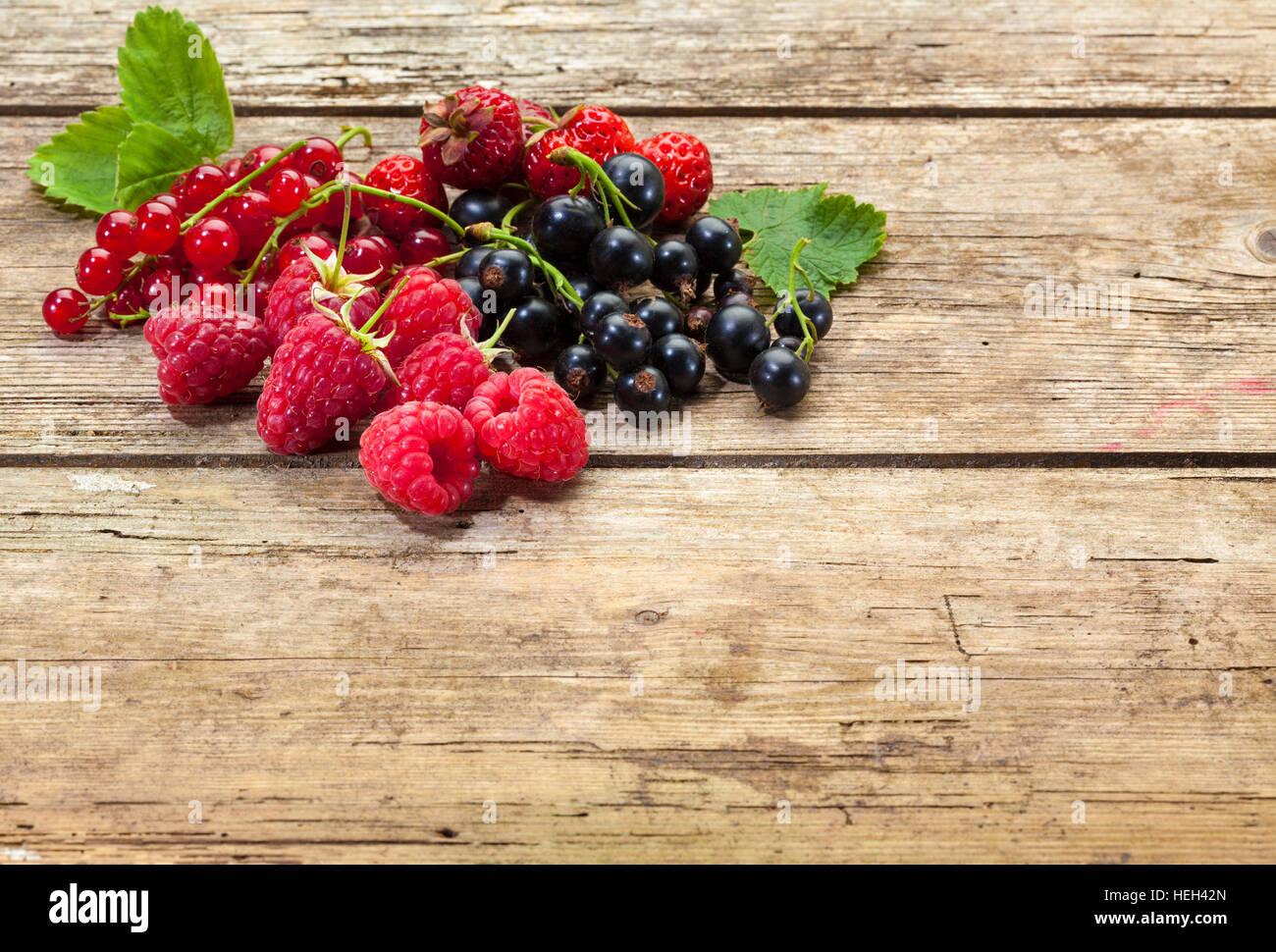 Berry fruit assortment on rustic wooden background with copy space ...