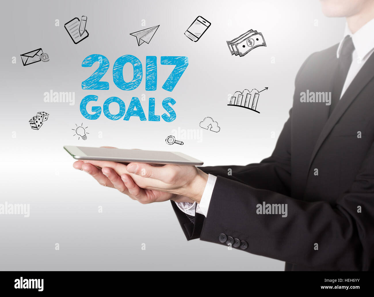2017 goals concept, young man holding a tablet computer Stock Photo - Alamy