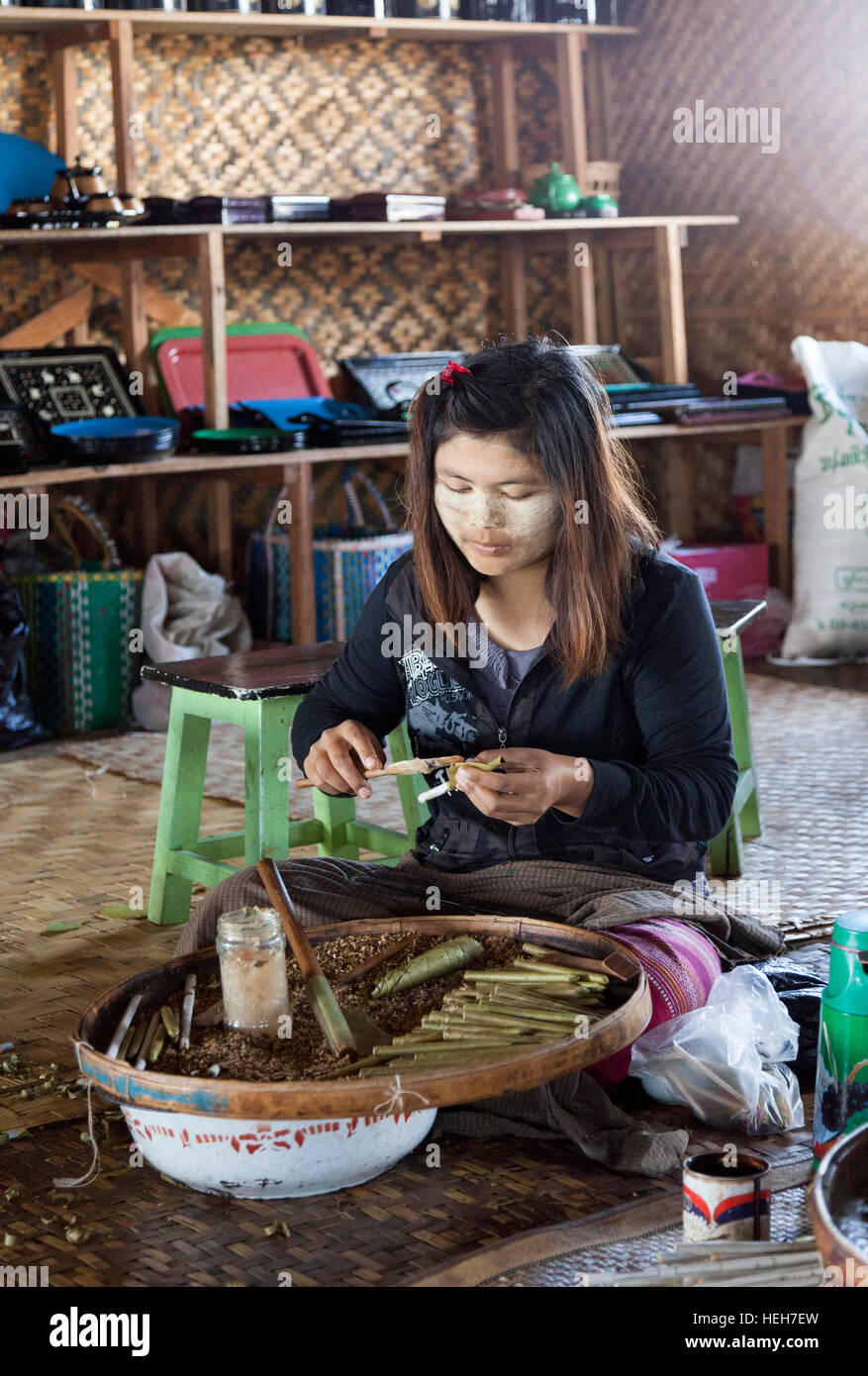 In a house of Lake Inle (Myanmar),a young female cigarette manufacturer ...