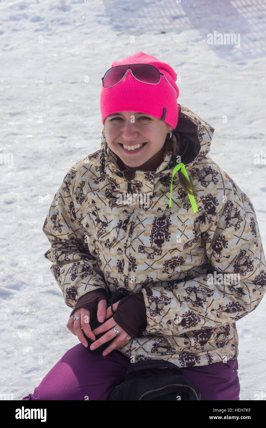 Smiling snowboarder girl near the snow mountain Stock Photo - Alamy
