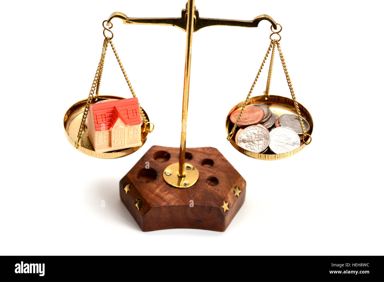 Small model house and cash money in balance – real estate concept Stock ...