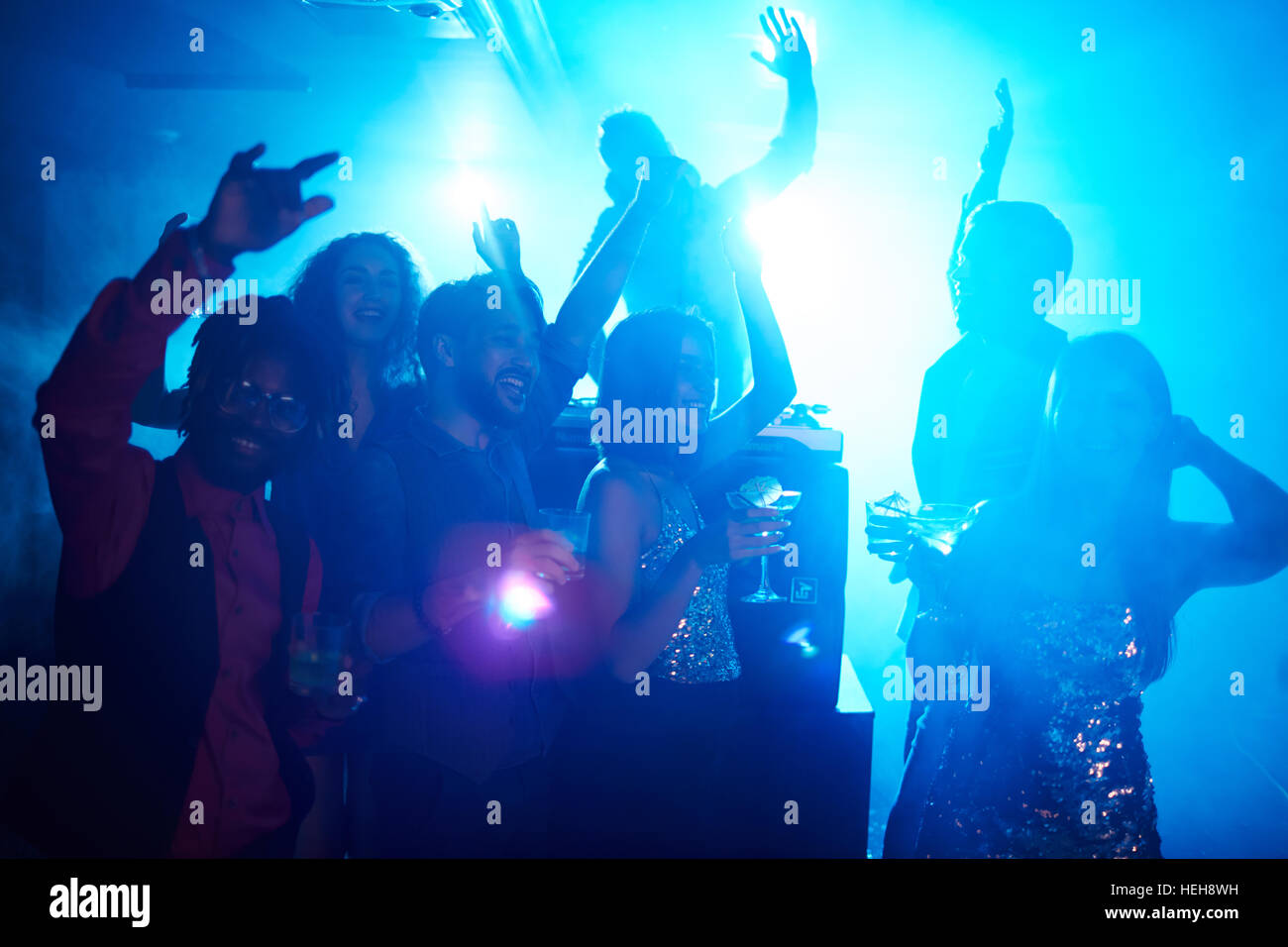 Intercultural friends with drinks having fun at party Stock Photo - Alamy