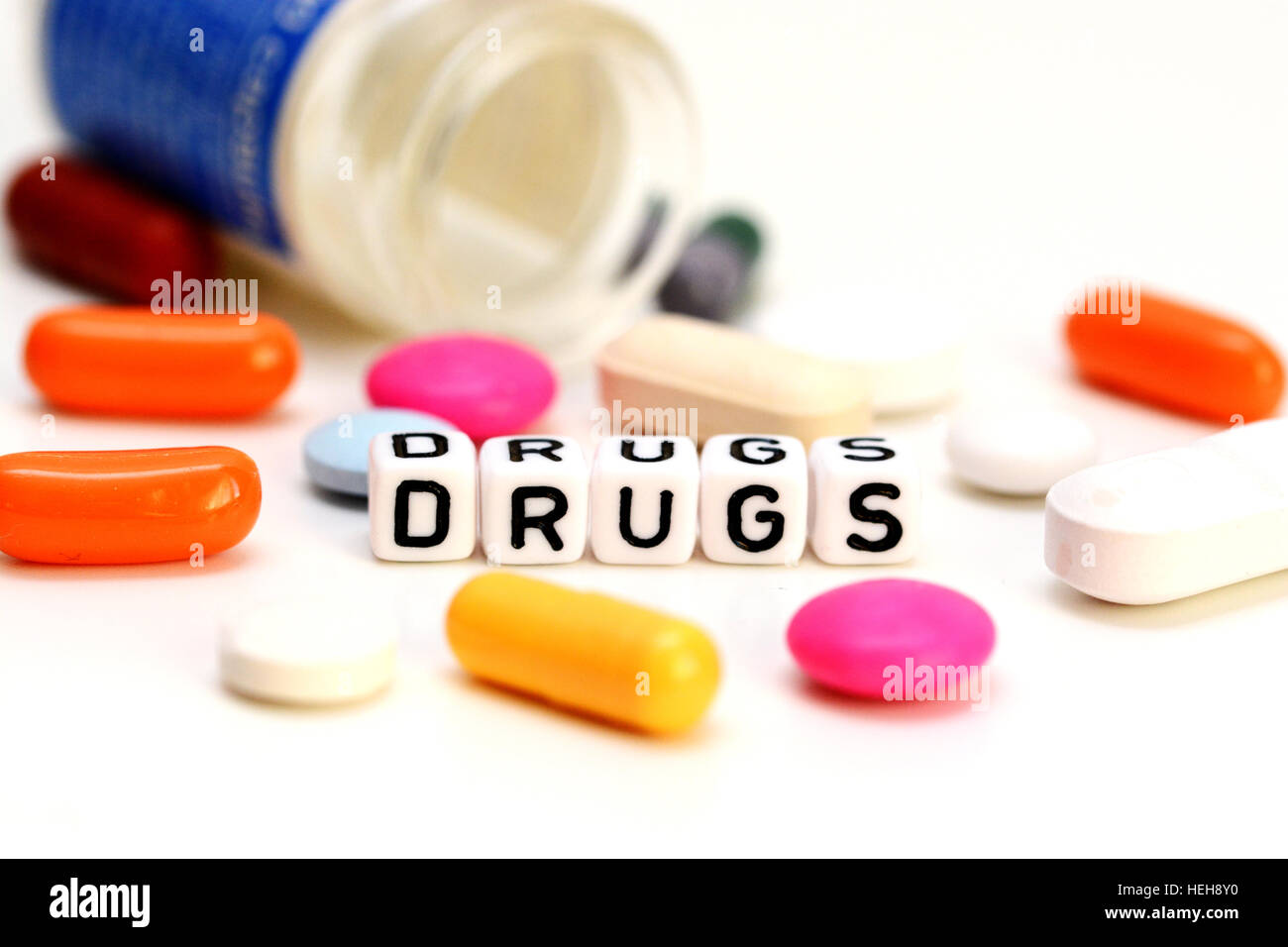 Colored pills and drugs word isolated on white background Stock Photo ...