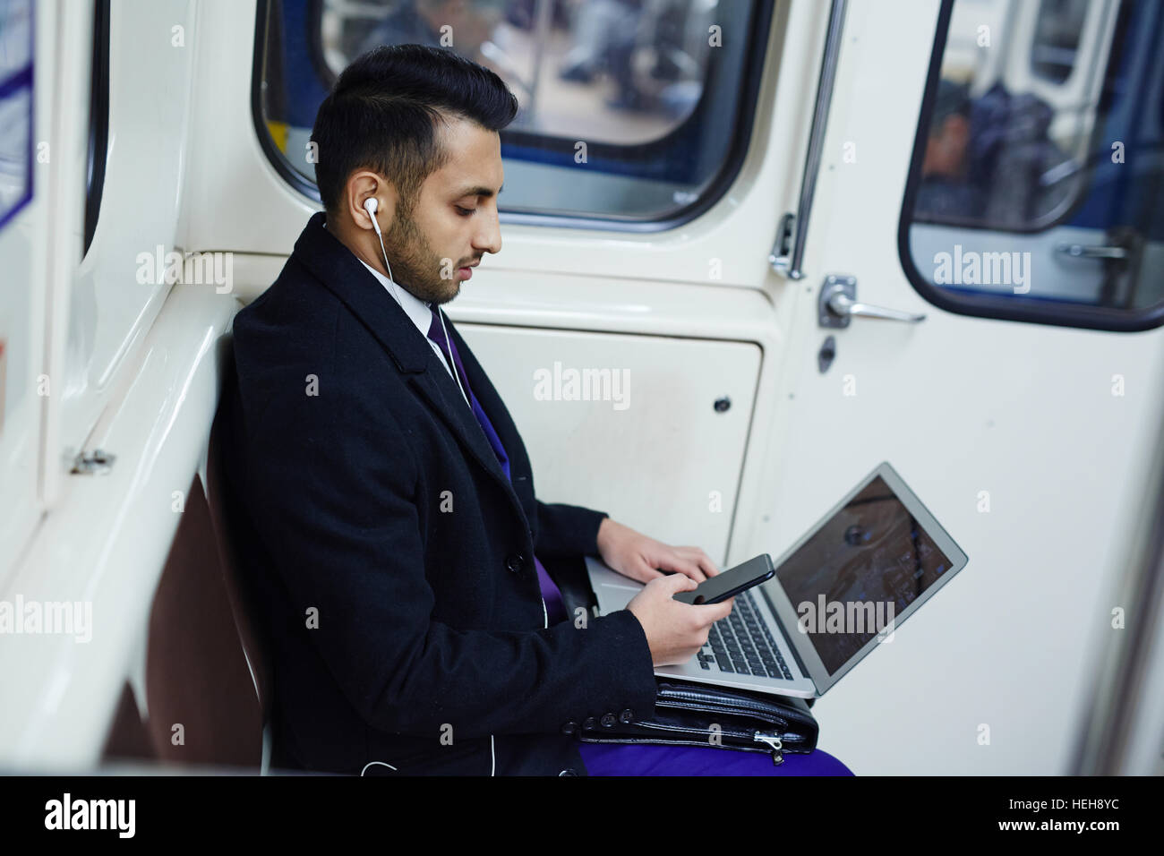 Business agent networking and messaging in subway Stock Photo - Alamy