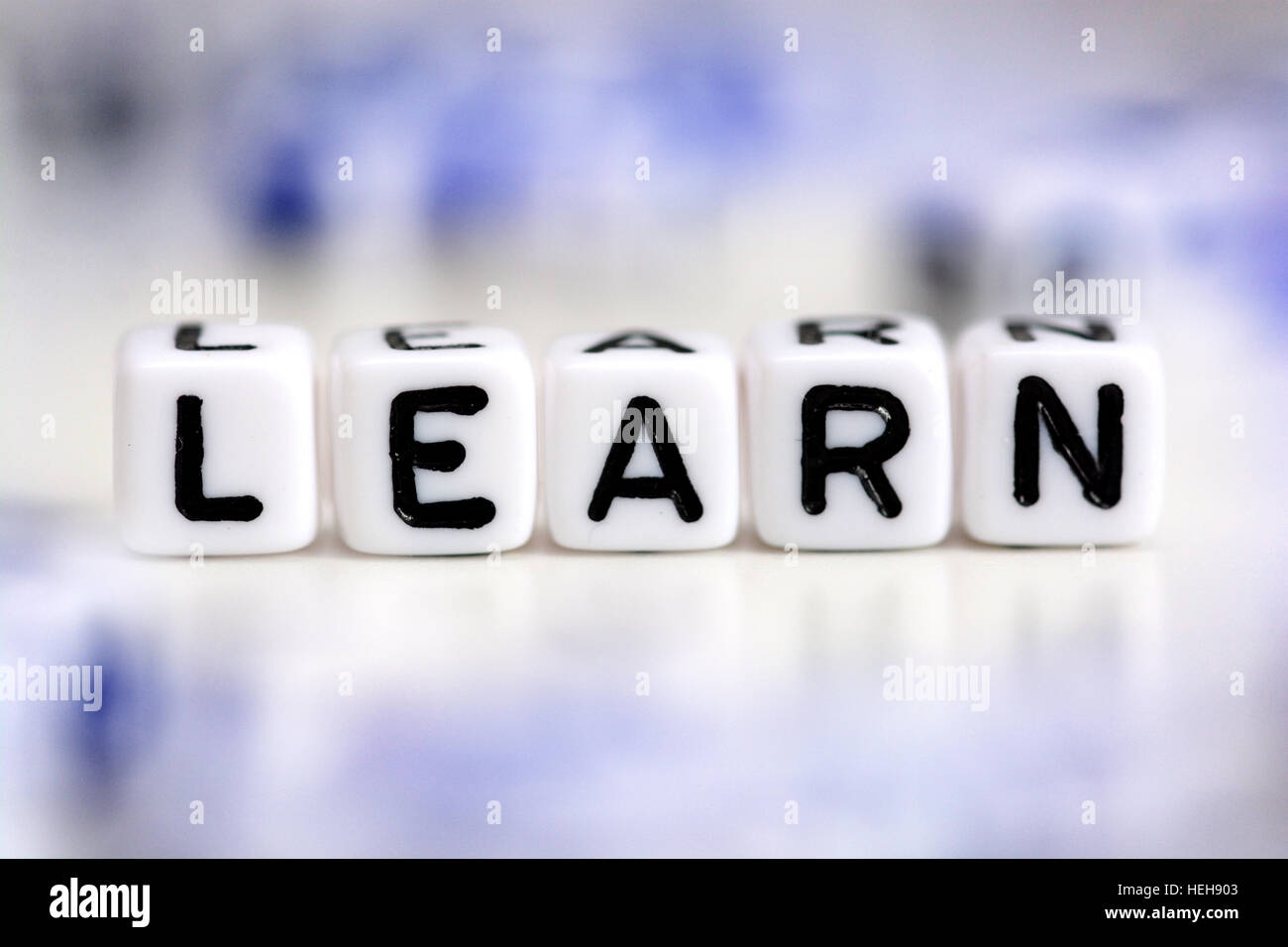 Learn word made from plastic beads on blue frame Stock Photo - Alamy