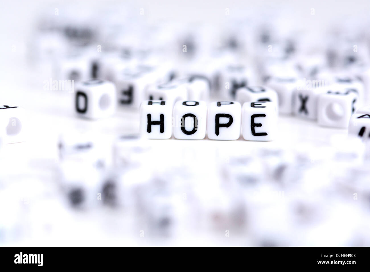 Hope word made from plastic alphabet blocks, stands in white background ...