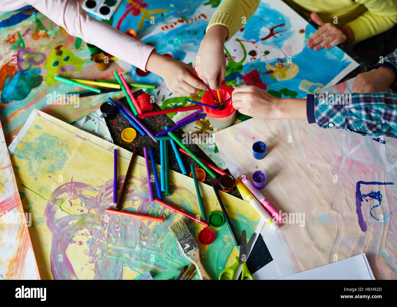 Overview of kids hands with paintbrushes learning to draw Stock Photo ...