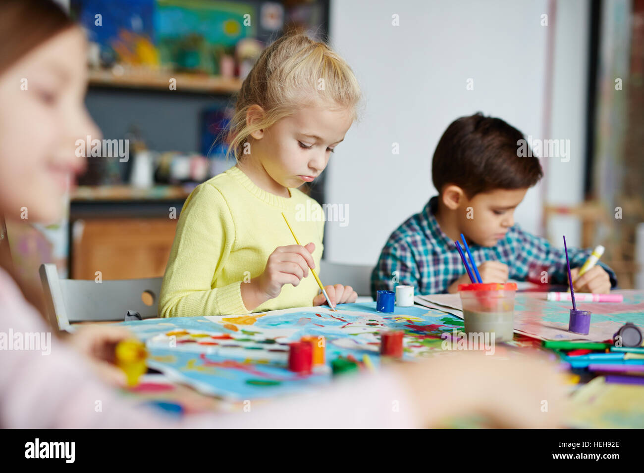Cute girl and her classmates drawing at lesson Stock Photo - Alamy