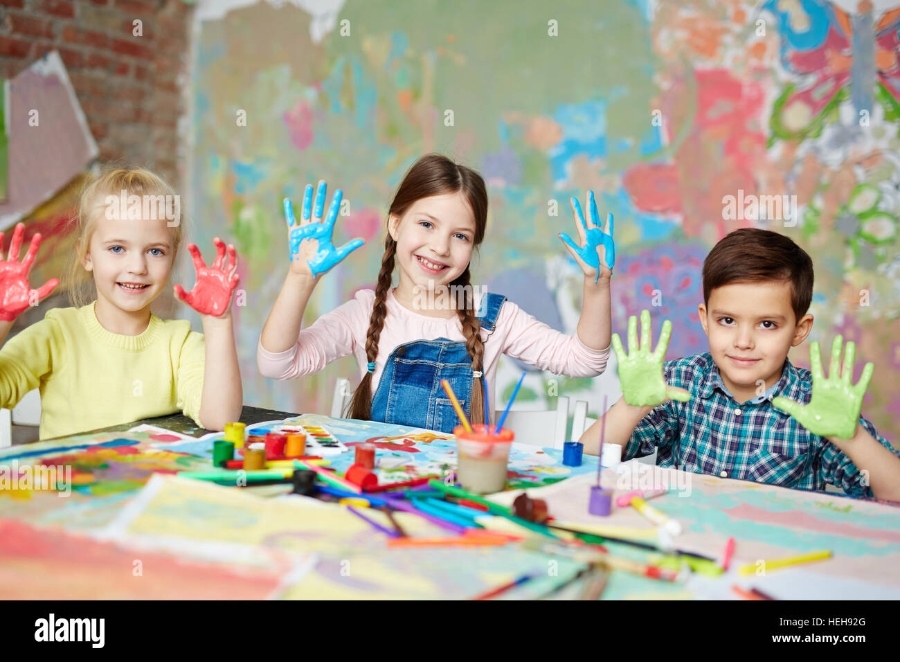 Kids with paint on palms looking at camera Stock Photo - Alamy