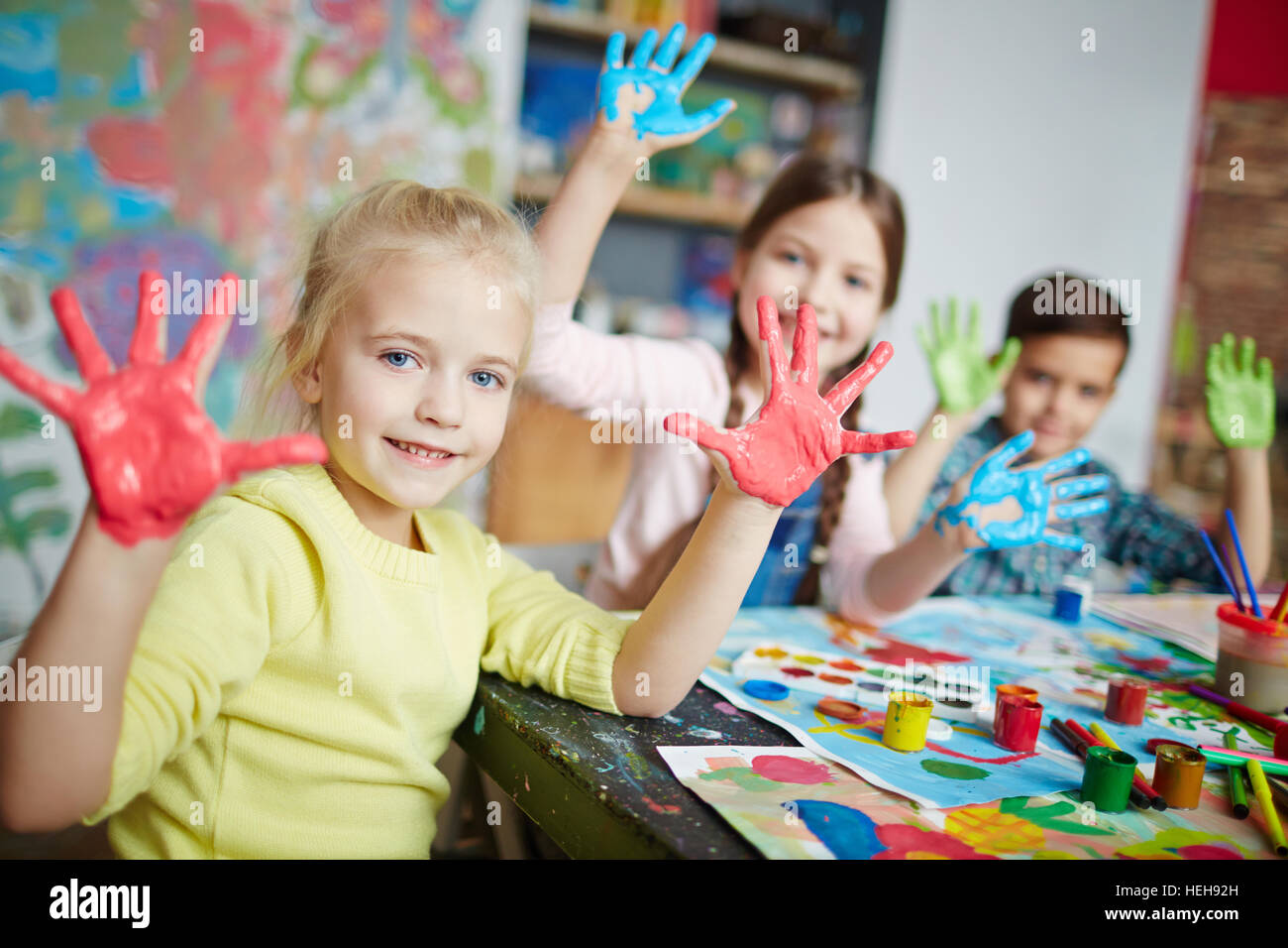 Elementary learners with hands in paint Stock Photo - Alamy