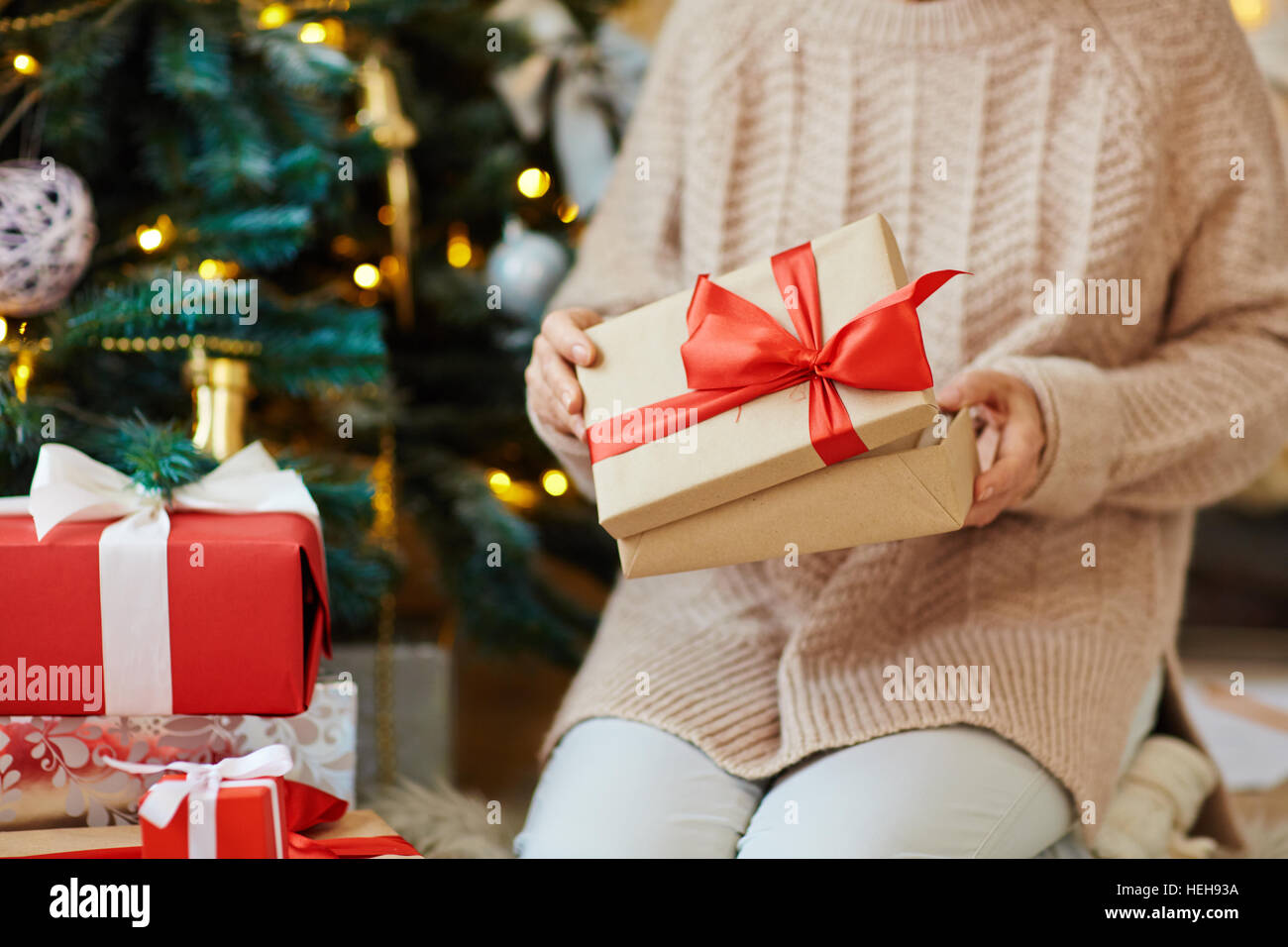 Woman opening gift-box with xmas present Stock Photo - Alamy