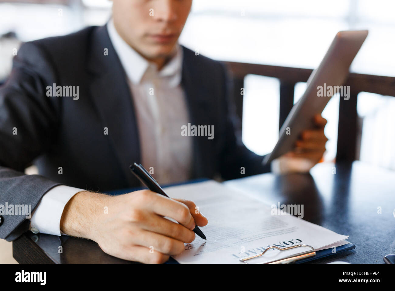 Man holding ballpoint over business contract Stock Photo - Alamy