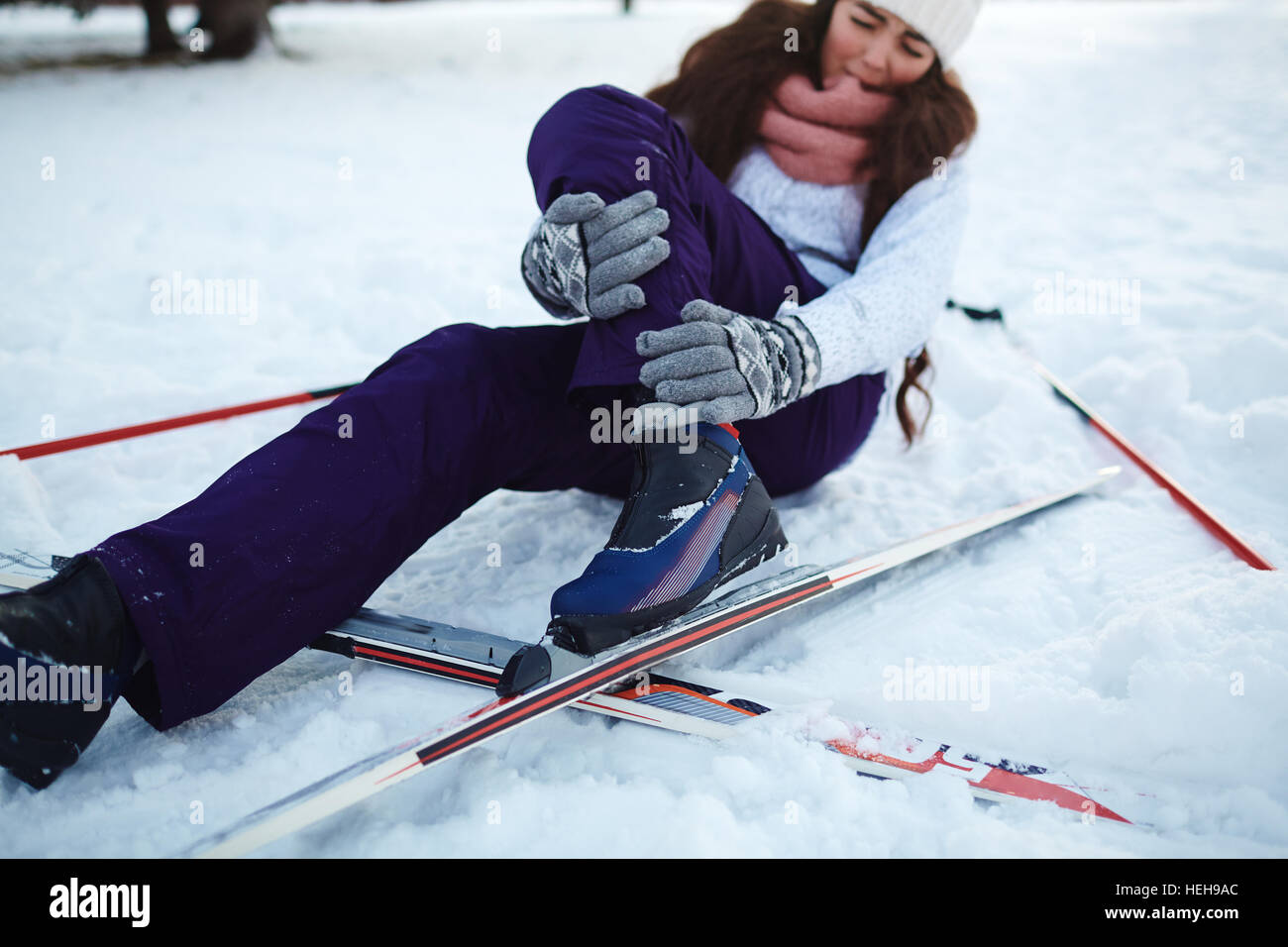 Active female fell down on snow during ski training Stock Photo - Alamy