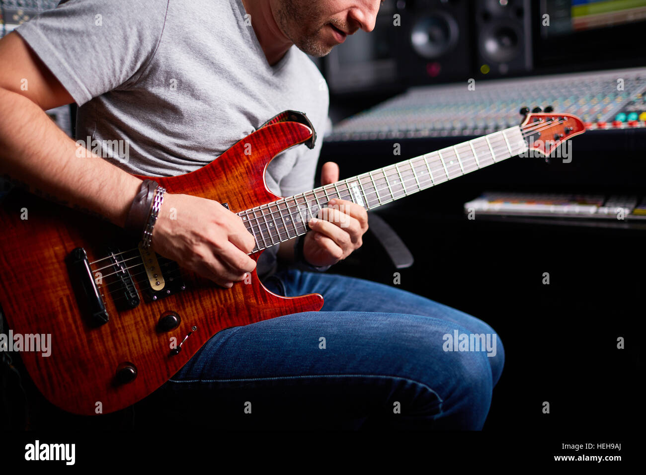 Young musician playing the guitar and recording music Stock Photo - Alamy