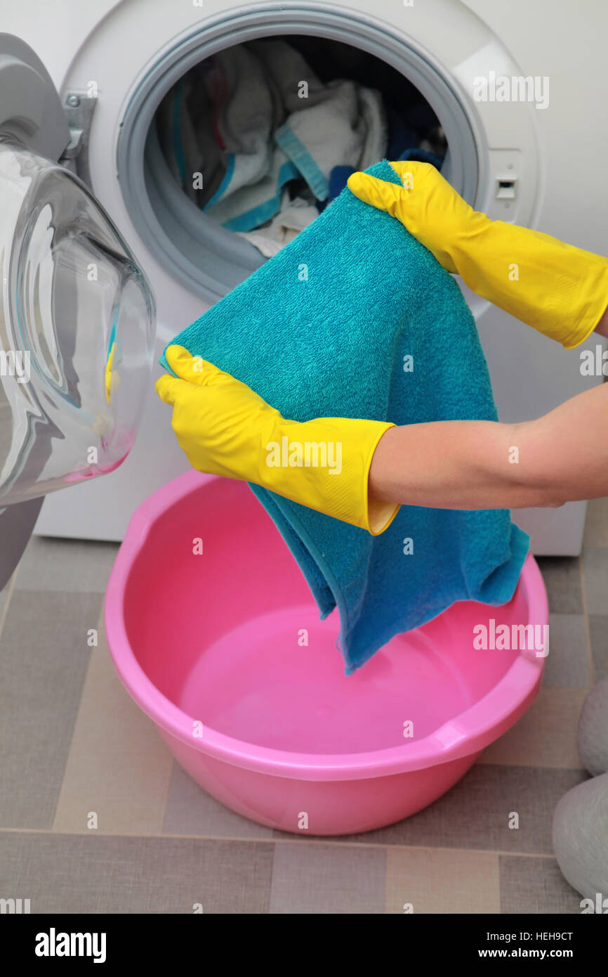 woman taking color clothes from washing machine Stock Photo - Alamy