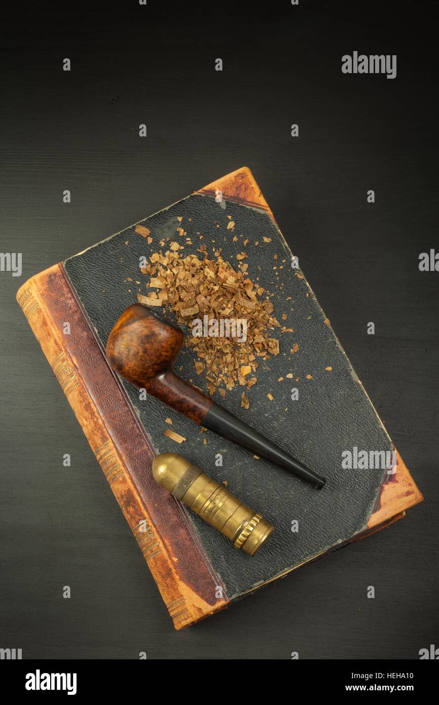 Smoking pipe and antique books. Tobacco pipe on ancient books. Relax by ...