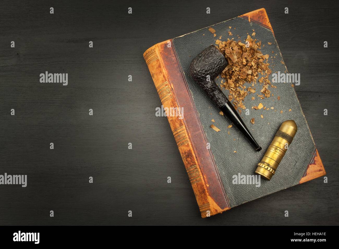 Smoking pipe and antique books. Tobacco pipe on ancient books. Relax by ...