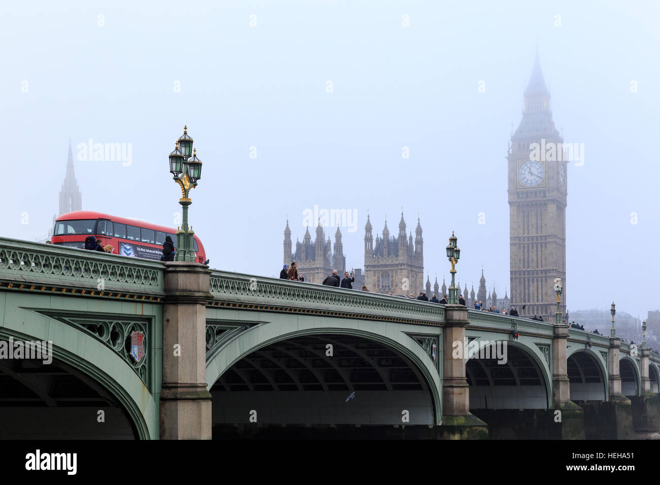 Red London bus passes over Westminster Bridge. In London, England. On ...
