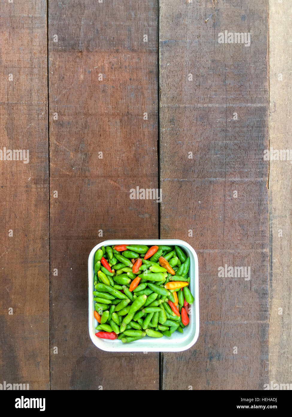Chillies on the top of the wooden table Stock Photo - Alamy
