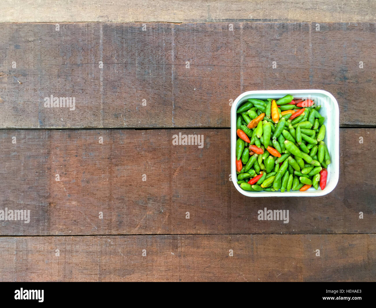 Chillies on the top of the wooden table Stock Photo - Alamy
