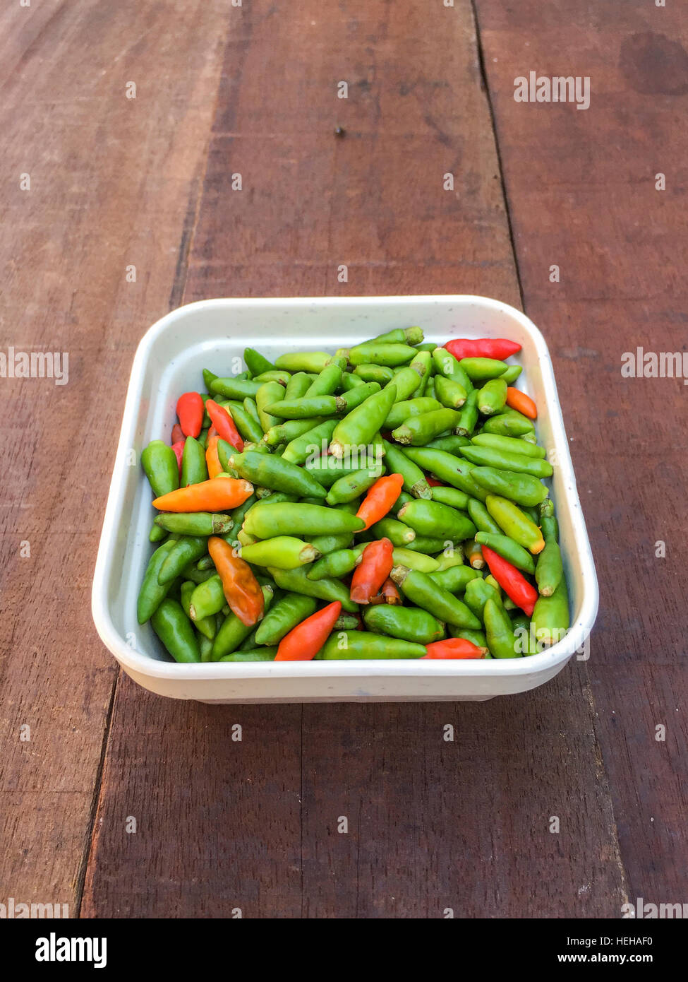 Chillies on the top of the wooden table Stock Photo - Alamy