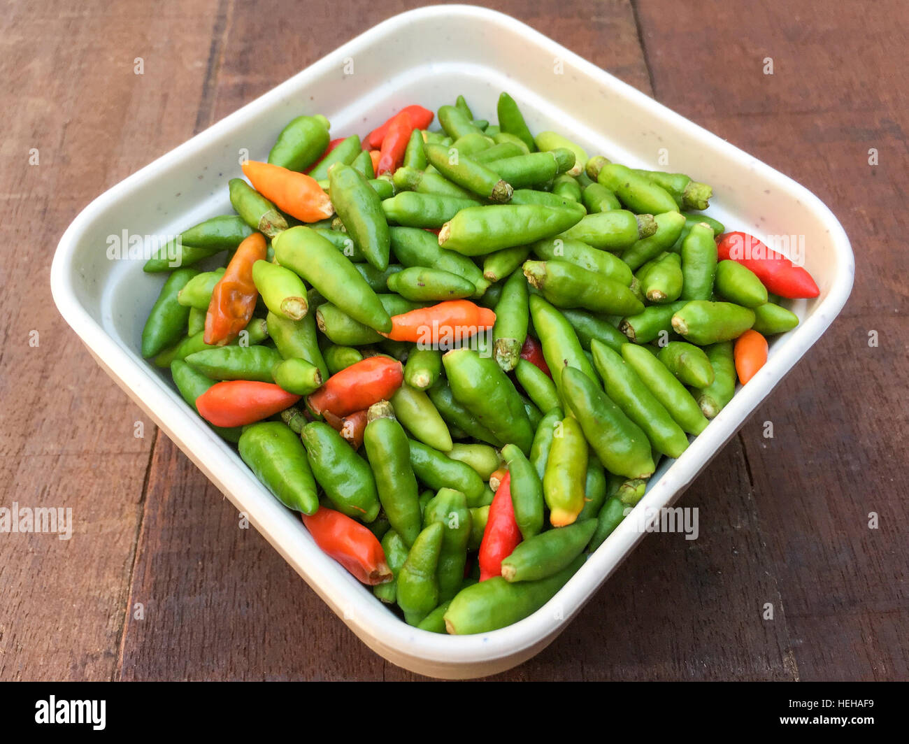 Chillies on the top of the wooden table Stock Photo - Alamy