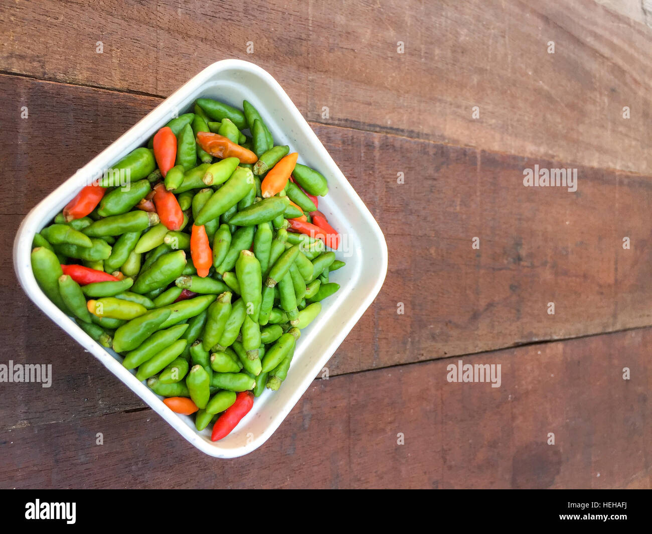 Chillies on the top of the wooden table Stock Photo - Alamy