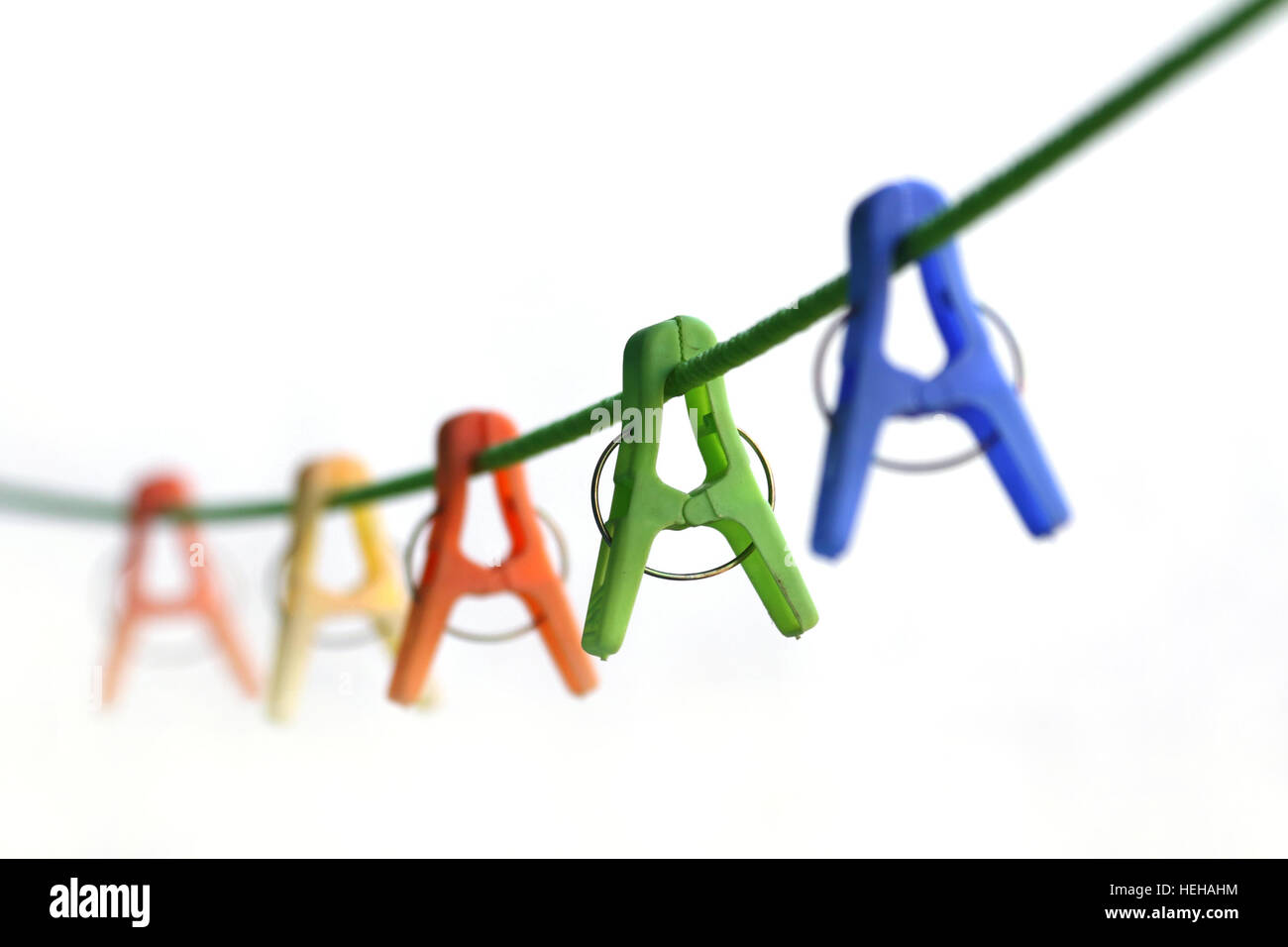 Colorful Clothes Pin Hanging on Rope Stock Photo - Alamy