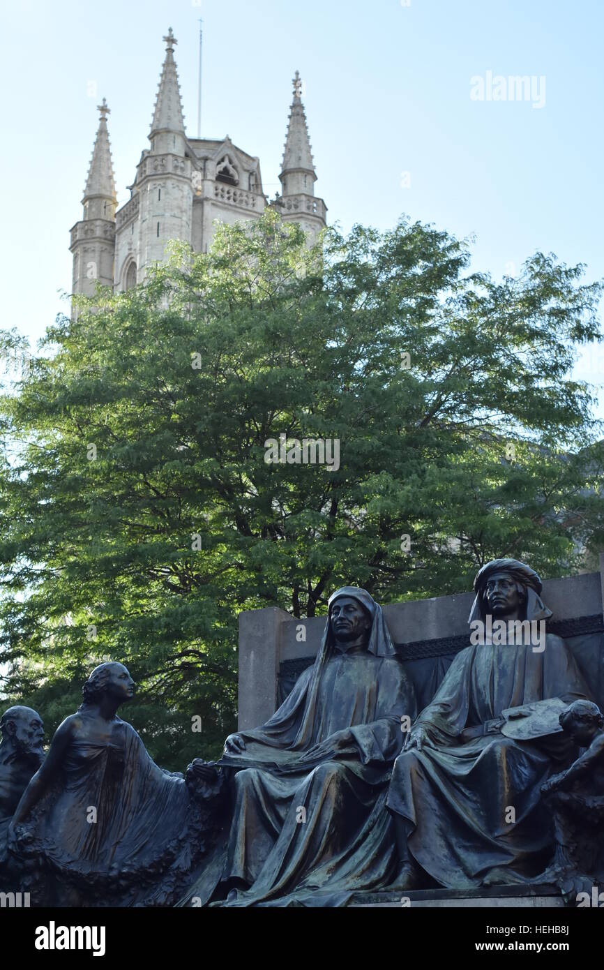 Group statues with tower in background Stock Photo - Alamy
