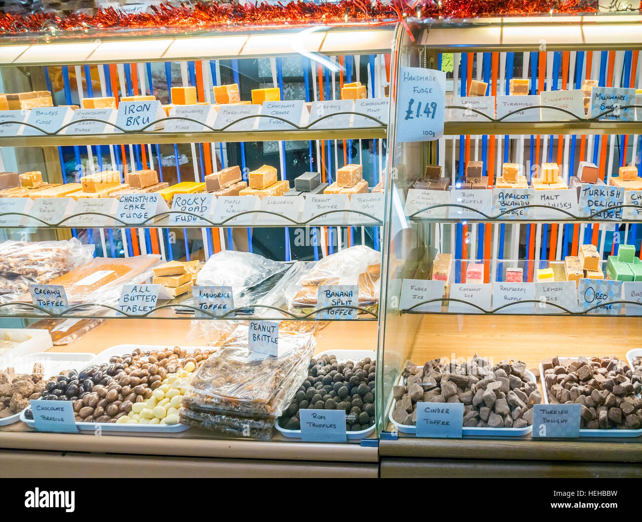 Sweet shop counter displaying many varieties of Hand Made Fudge Toffee ...
