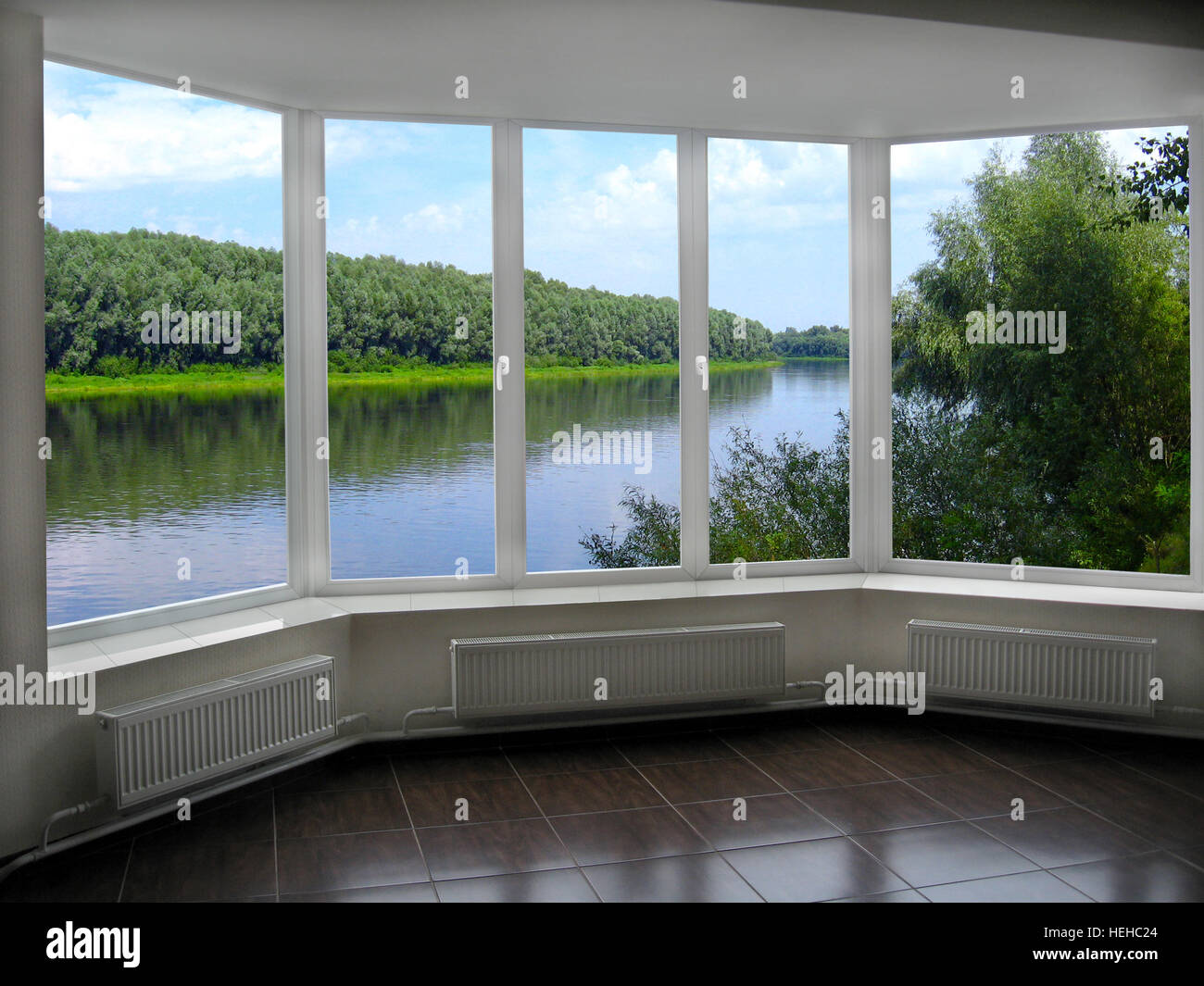 big windows with window overlooking the summer river and forest Stock ...