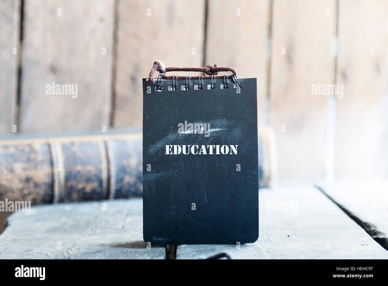 education - lettering on the label and old book Stock Photo - Alamy