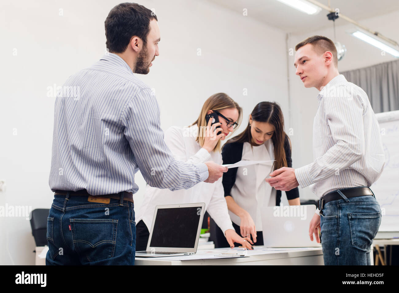 Group of four diverse cheerful co-workers taking self portrait and ...